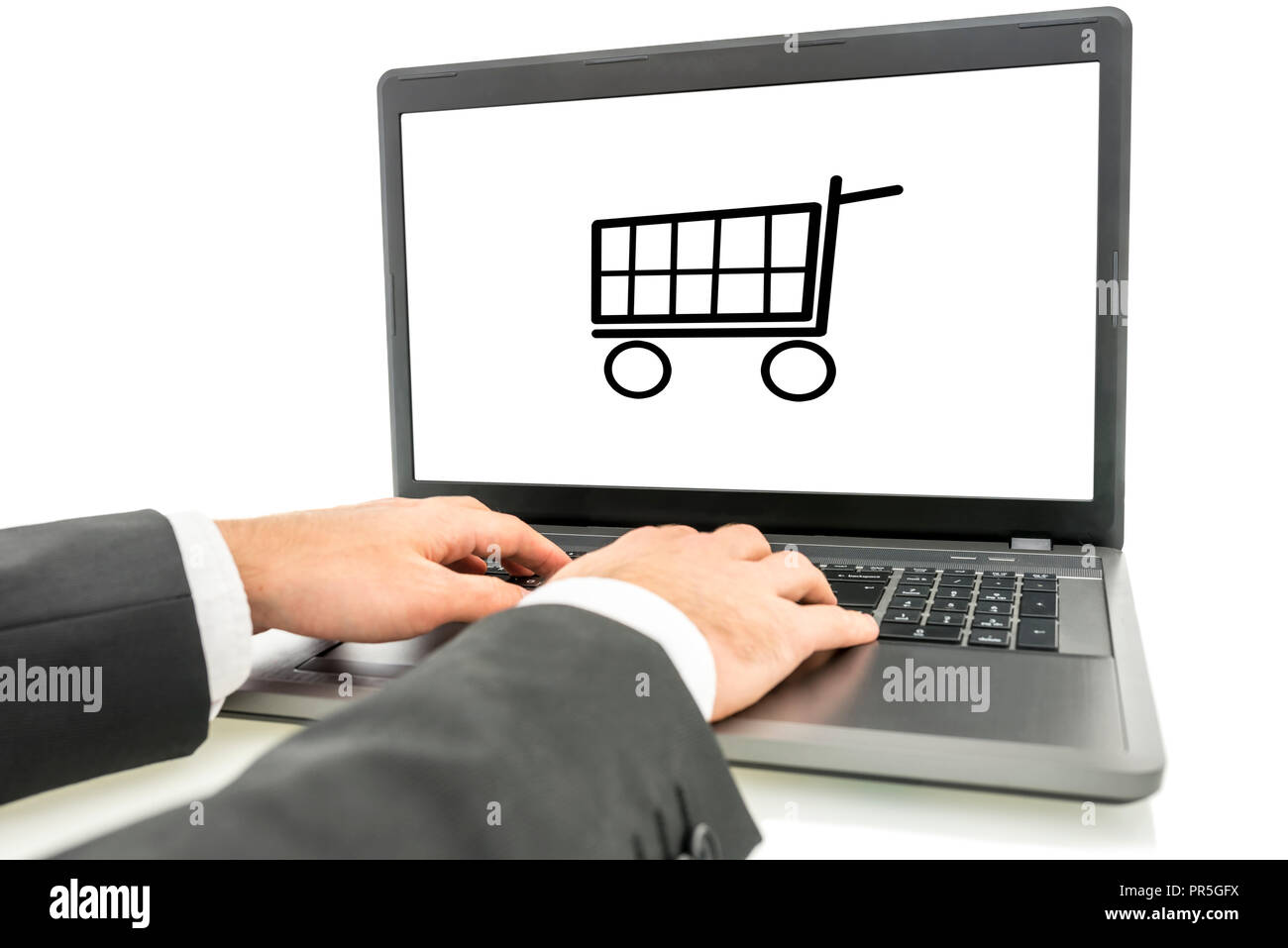 Businessman shopping online on his laptop computer with the shopping ...