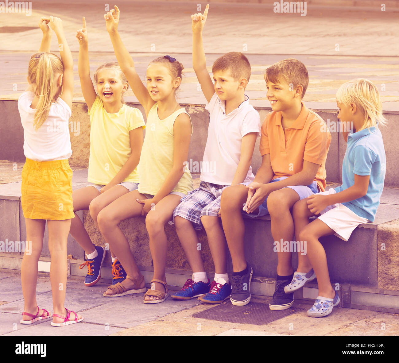 portrait of smiling european children spending time outside and playing ...