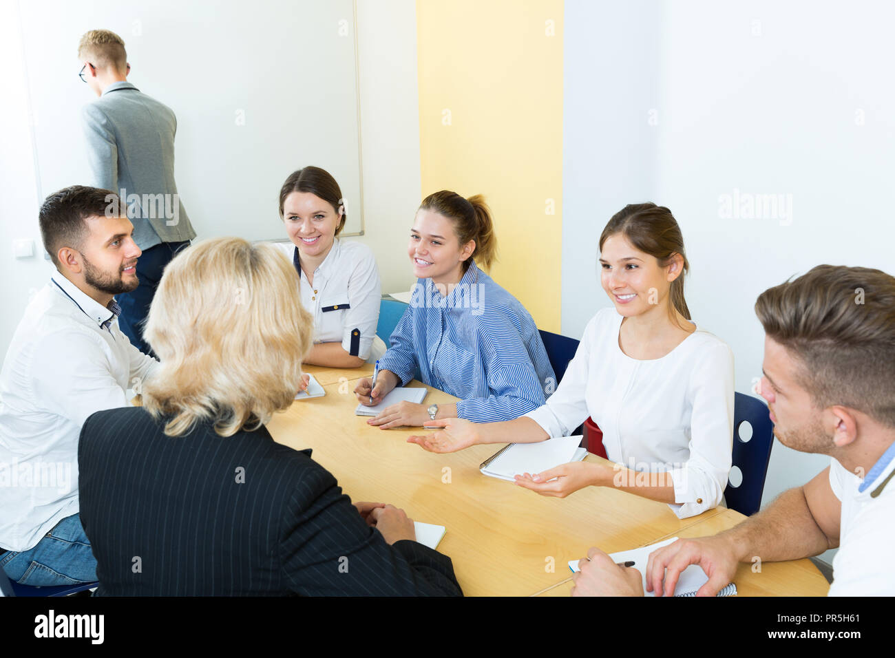 Students doing group brainstorming in auditorium while guy student ...