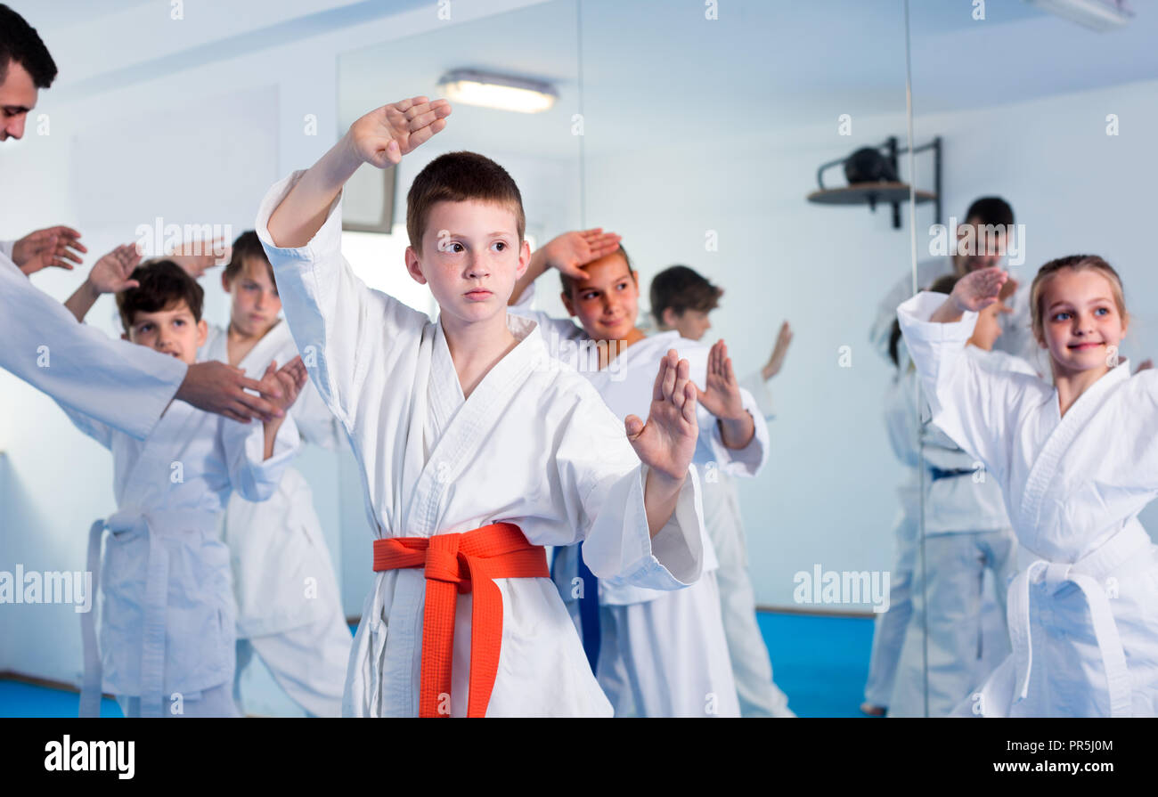 Trainer is showing how to do moves rigth in karate class Stock Photo ...