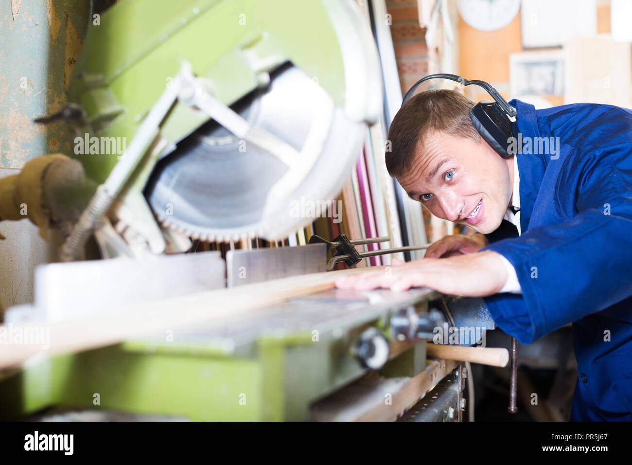 portrait of positive spanish man in uniform working on electrical ...