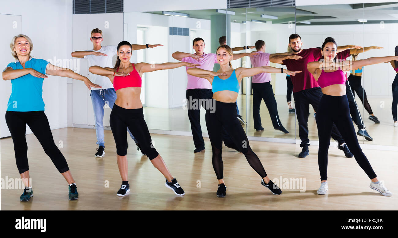 friendly men and ladies dancing aerobics at lesson in the dance class ...