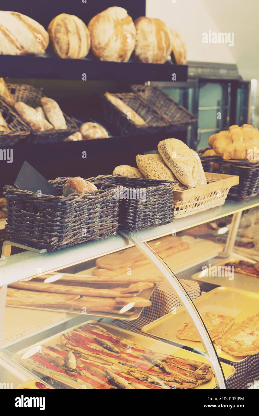 Modern spanish bakery with different kinds of bread, cakes and buns ...