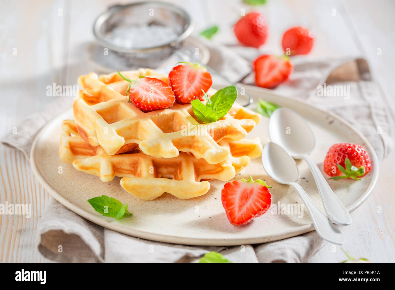 Sweet wafers with powdered sugar and fruits Stock Photo - Alamy