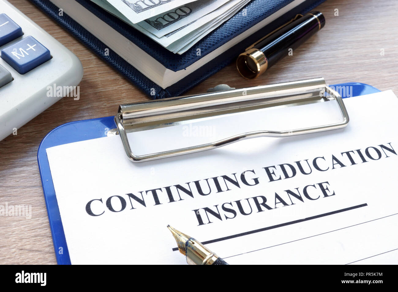 Continuing Education Insurance policy and the pen Stock Photo - Alamy