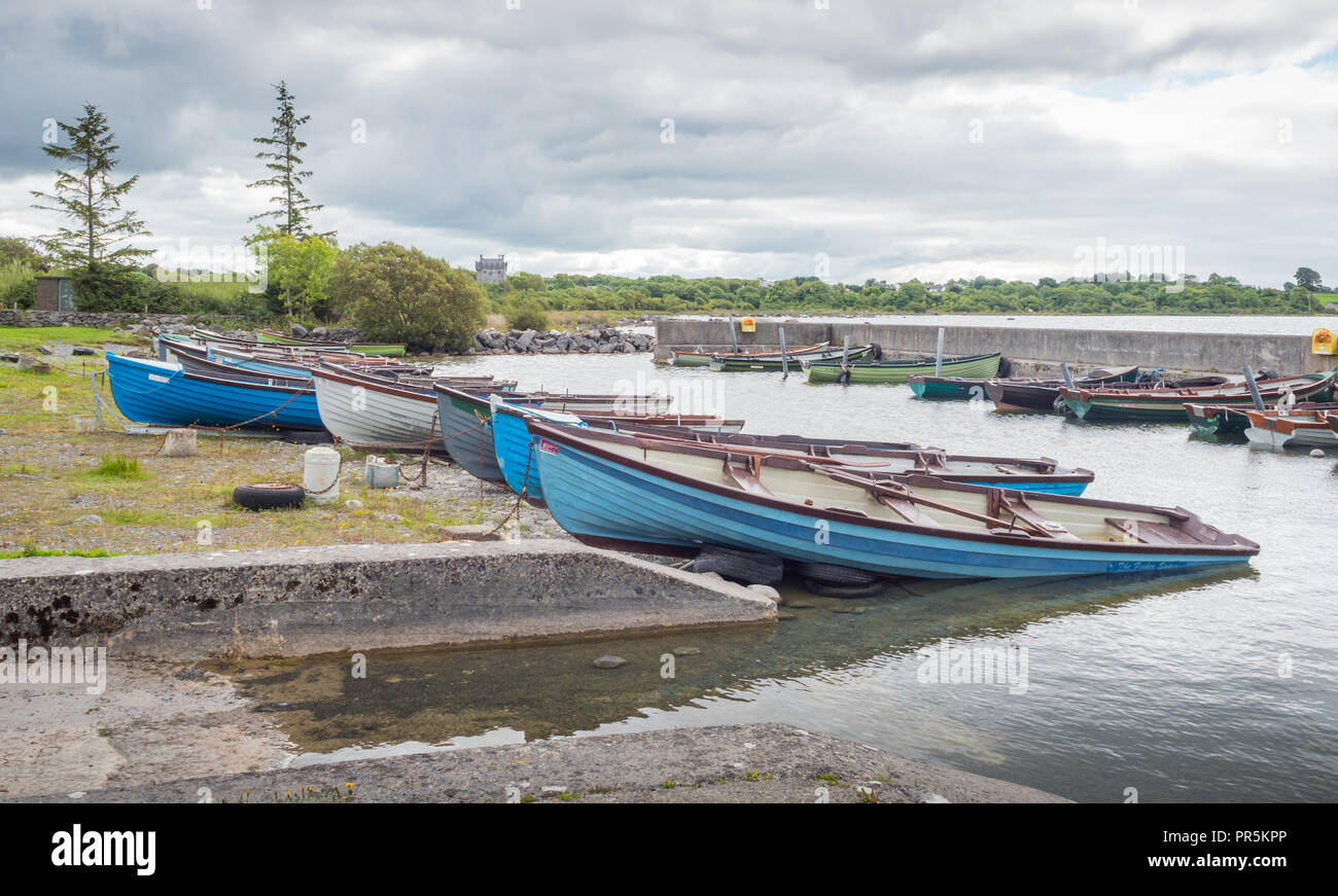 Rowing boats lined up at Annaghdown Pier in County Galway in Ireland ...