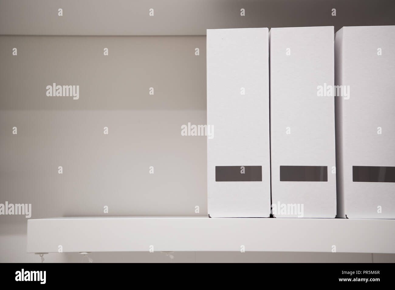 White magazine files on a shelf at home office Stock Photo - Alamy