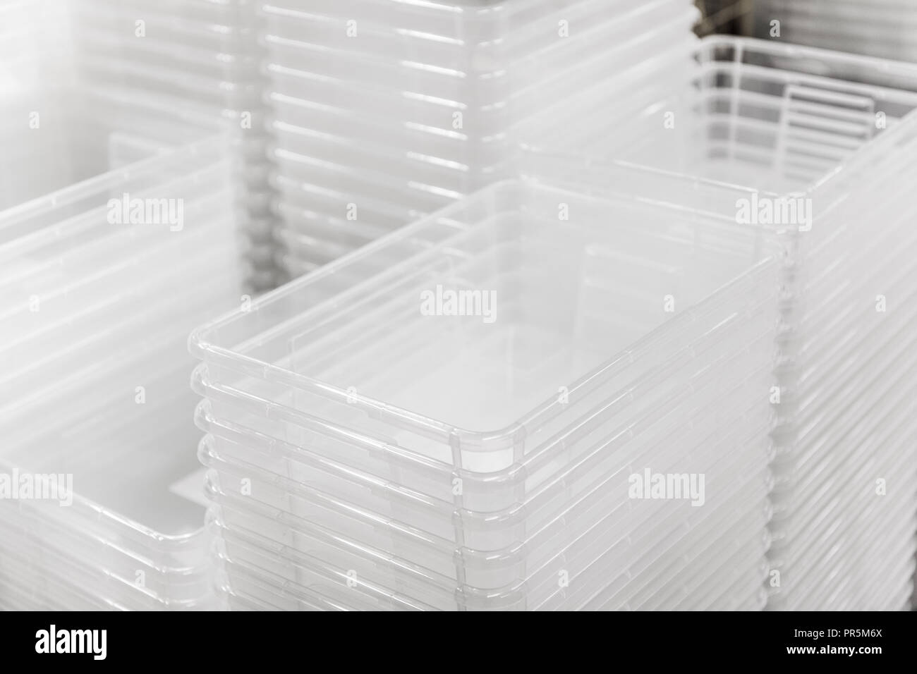 Folded transparent plastic containers boxes at store Stock Photo - Alamy