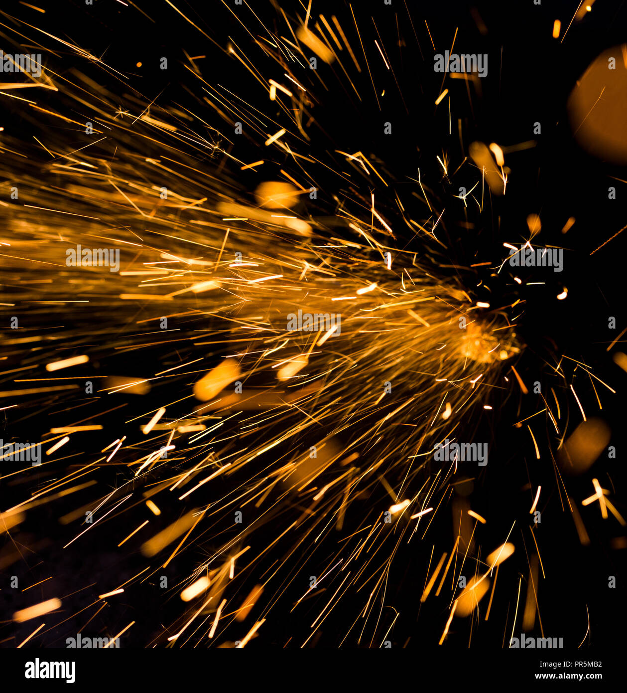 Bright yellow sparks on a black background Stock Photo - Alamy