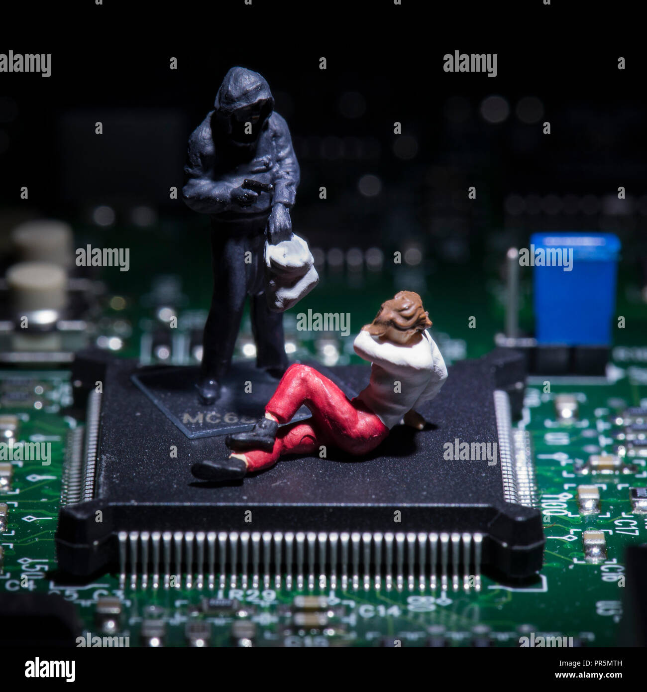 toy figures on top a computer chip - concept cyber crime Stock Photo ...