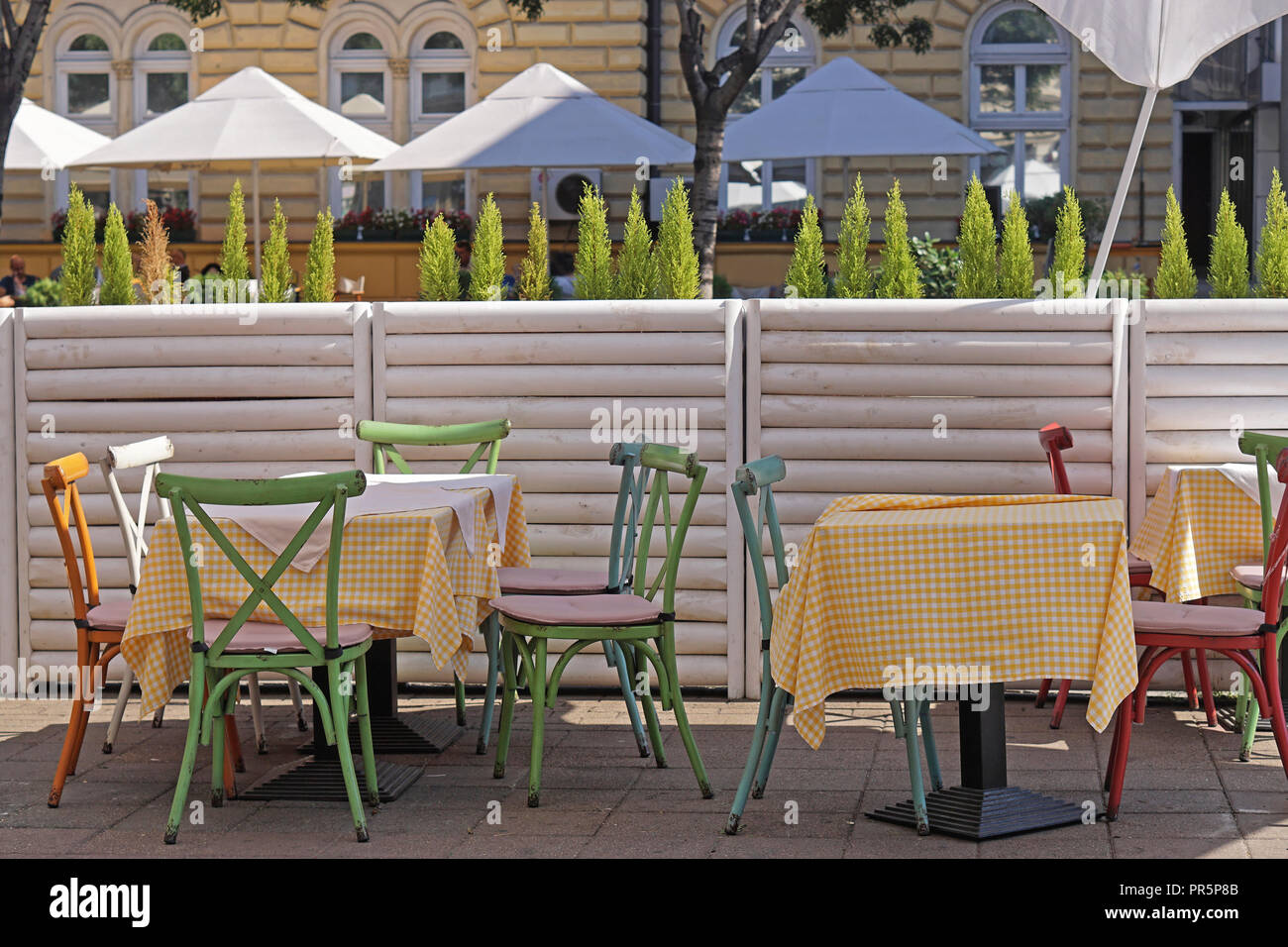 Cafe tables and chairs at city street outdoor Stock Photo - Alamy
