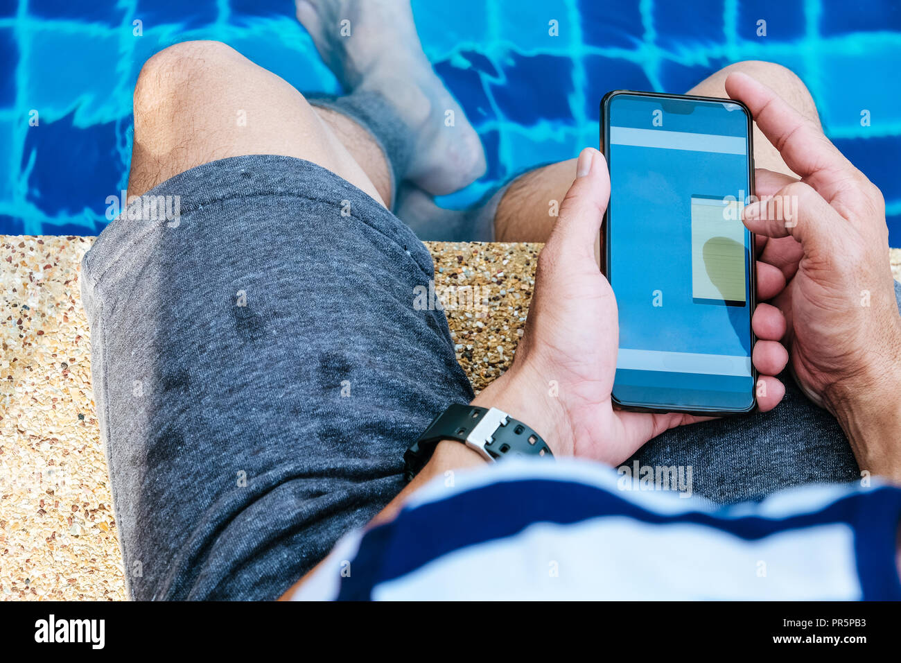 Modern man using cellphone on the pool Stock Photo - Alamy