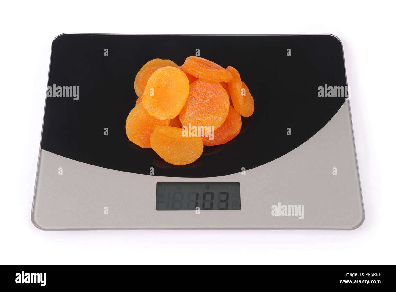 Dried apricot on kitchen scale isolated on white background Stock Photo ...