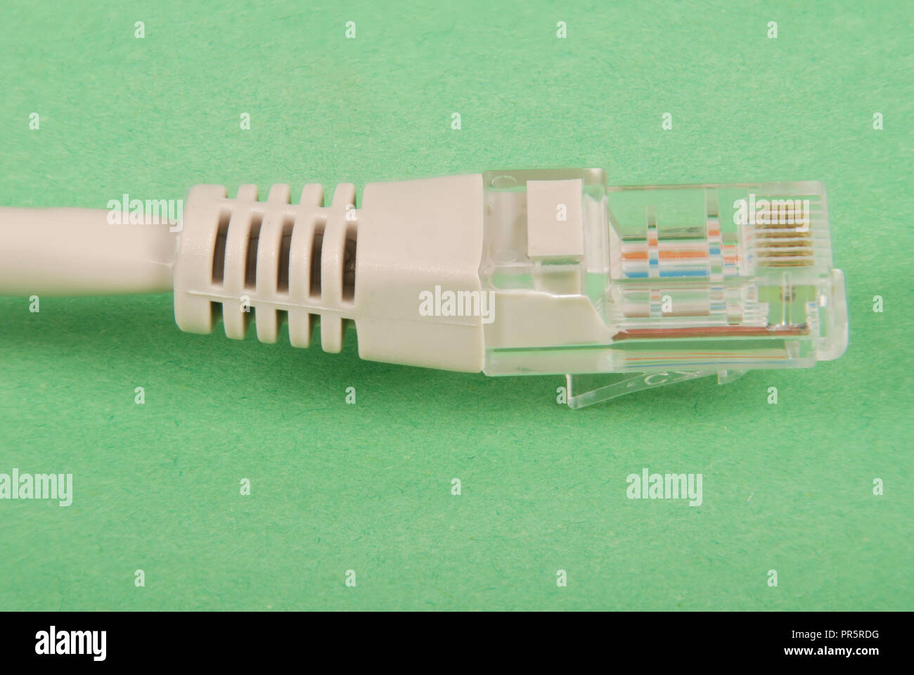 Lan cable and connector RJ45, isolated on green background Stock Photo ...