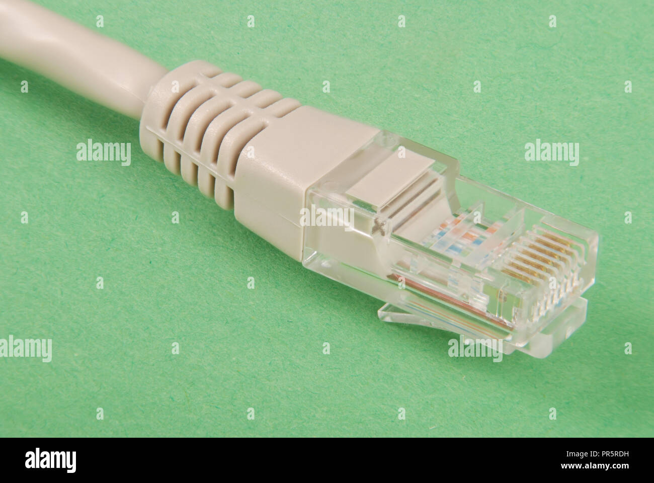Lan cable and connector RJ45, isolated on green background Stock Photo ...
