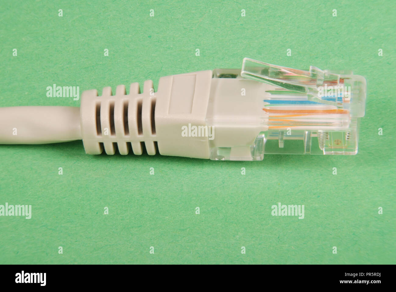 Lan cable and connector RJ45, isolated on green background Stock Photo ...