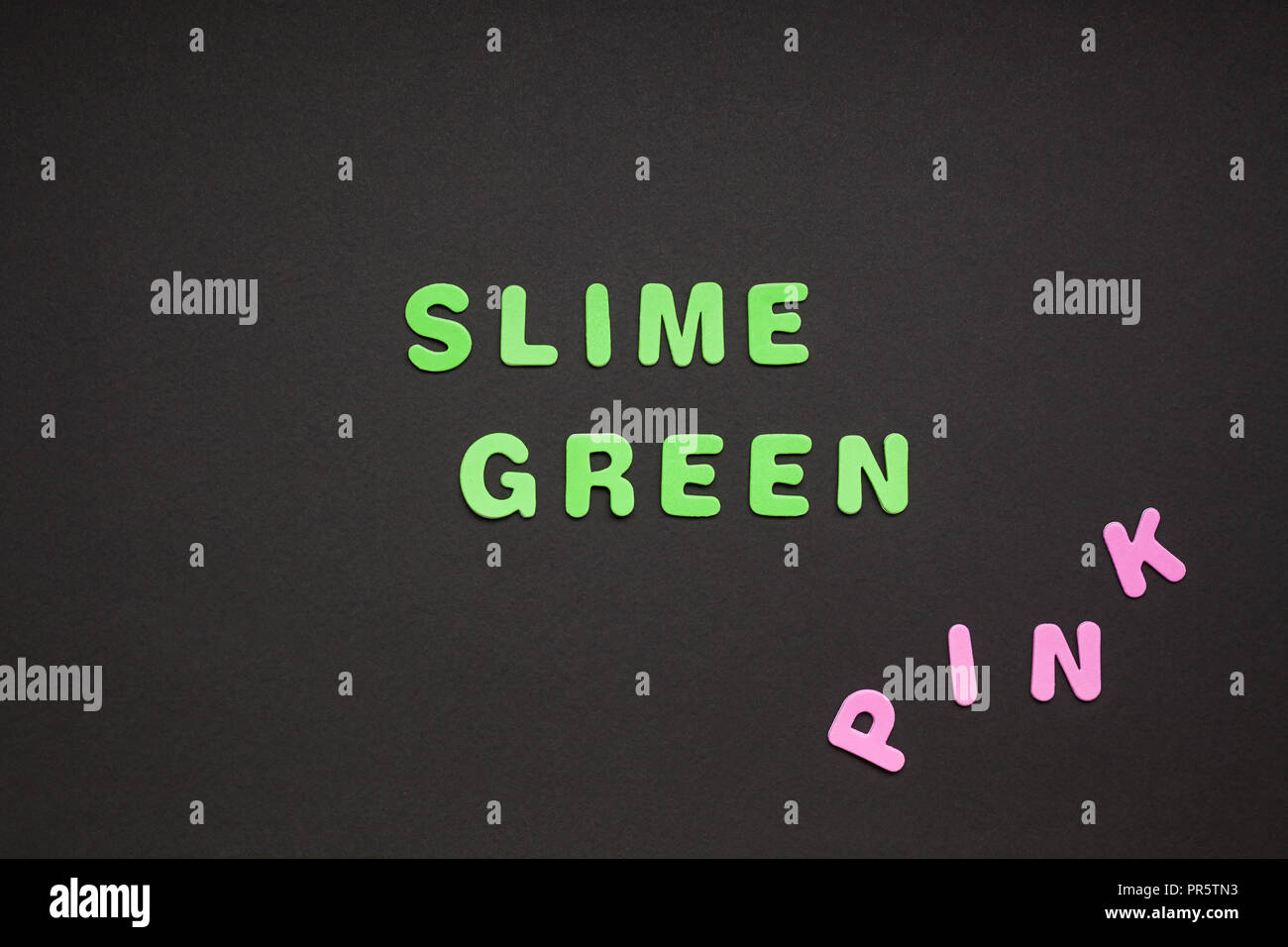 Creative colorful text made from plastic letters Slime green writing on ...
