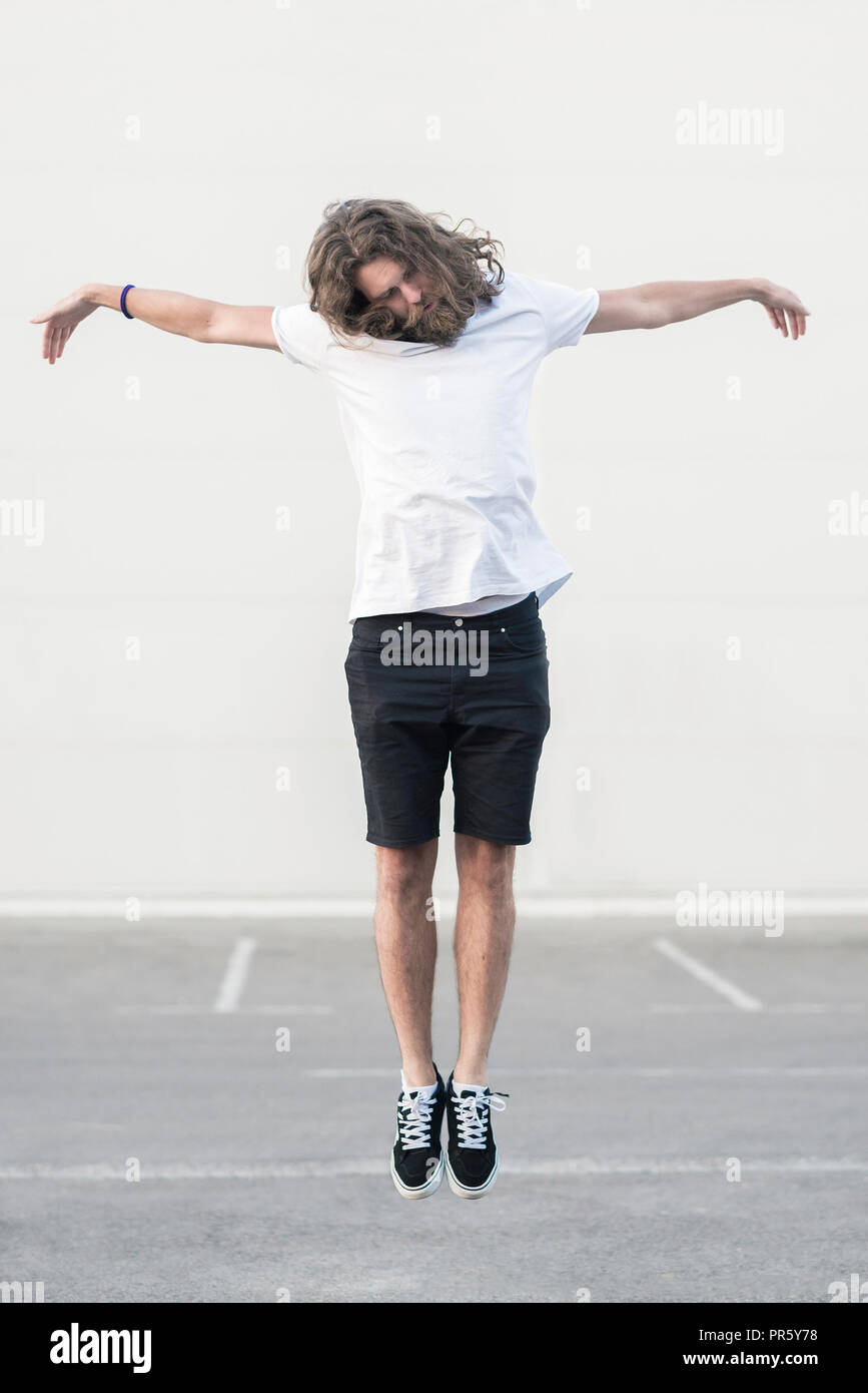 Young man in a Jesus Christ suspended pose concept Stock Photo - Alamy