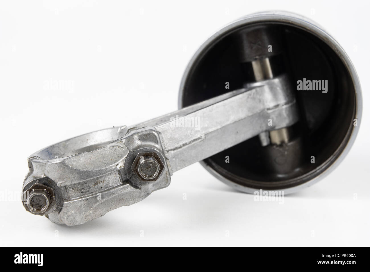 A small combustion engine piston on a white table. Spare parts for ...