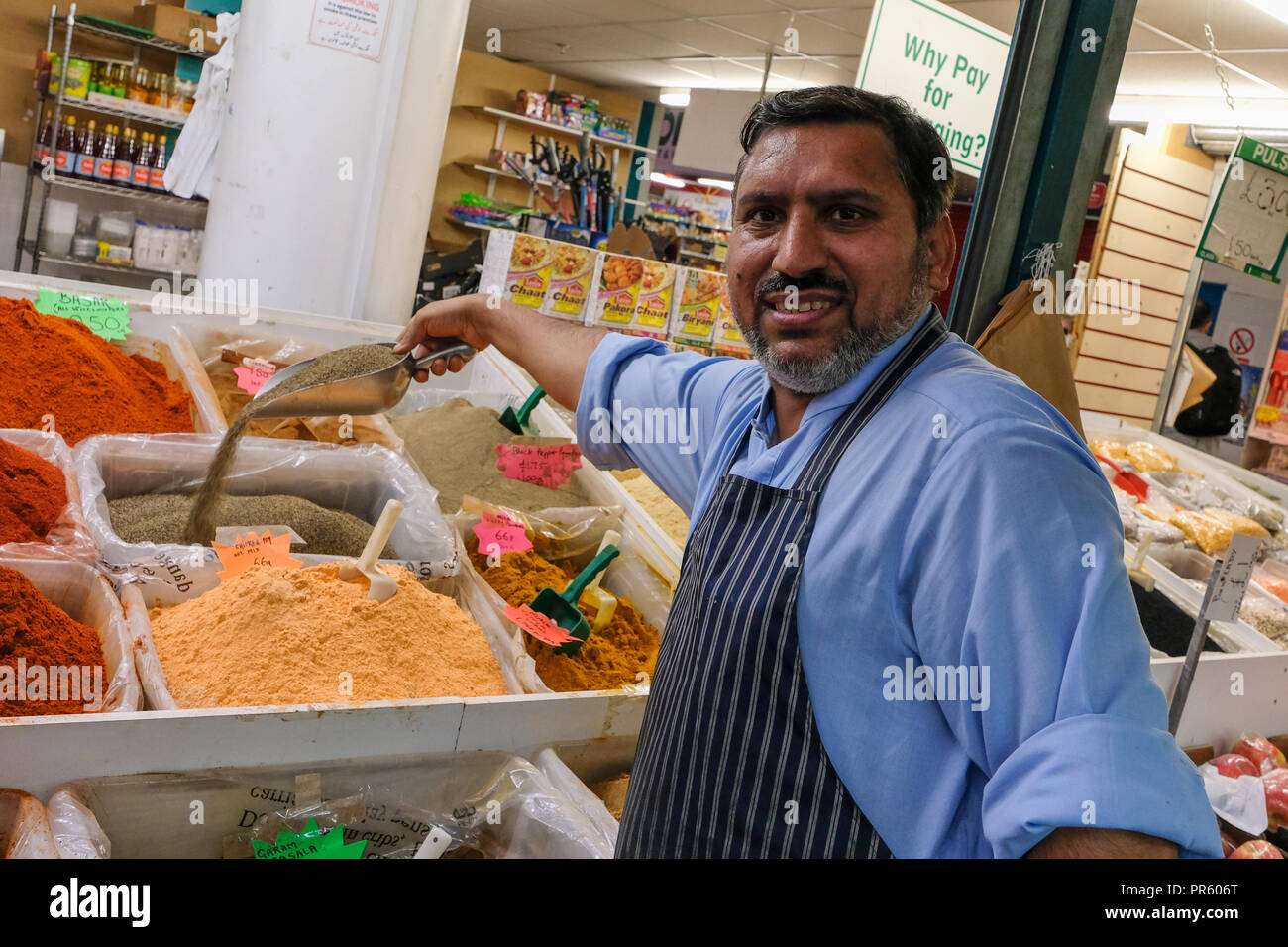 Stall holder selling spices in Bradford's Oastler shopping centre ...