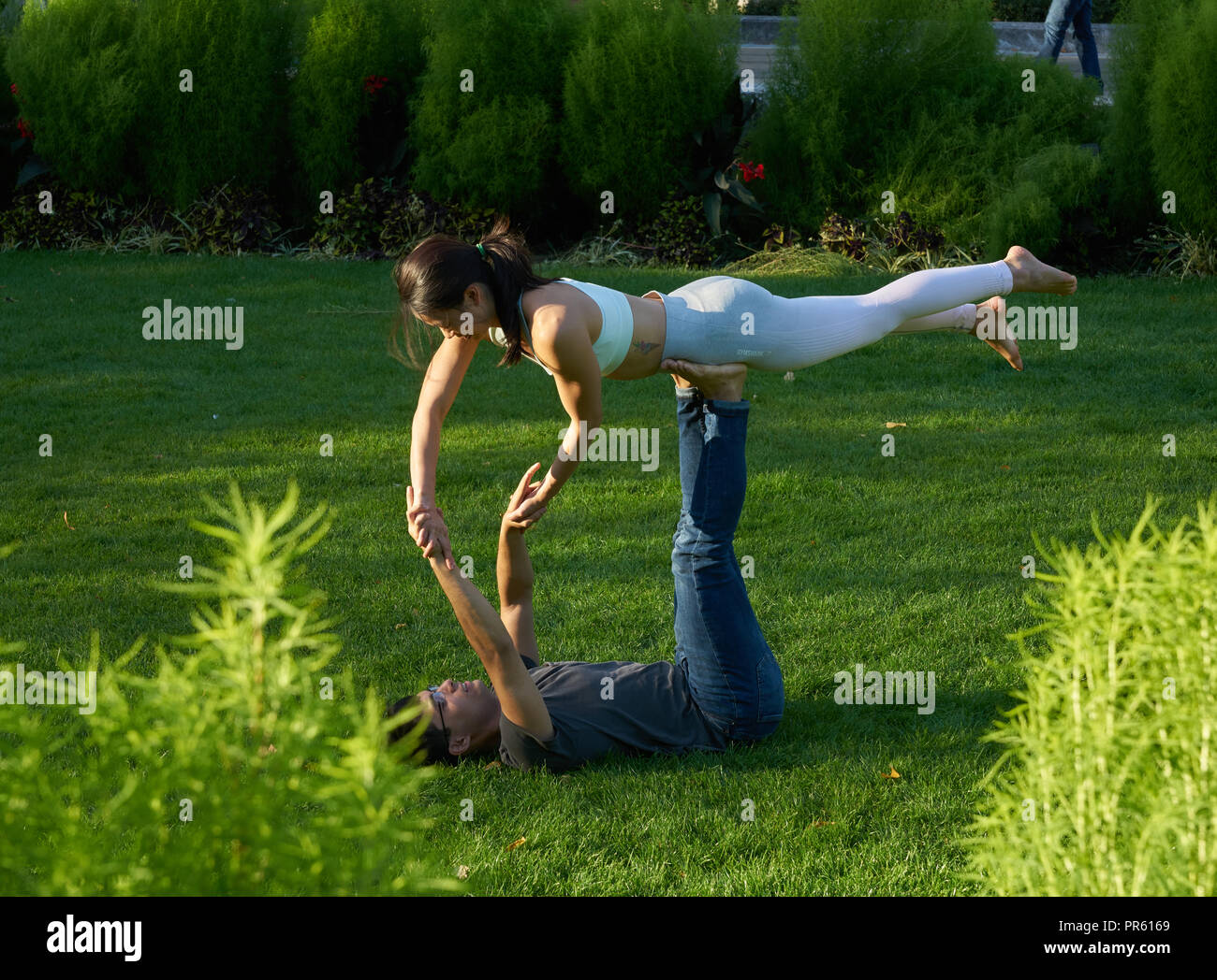 acrobatics fun in park man and woman Stock Photo - Alamy