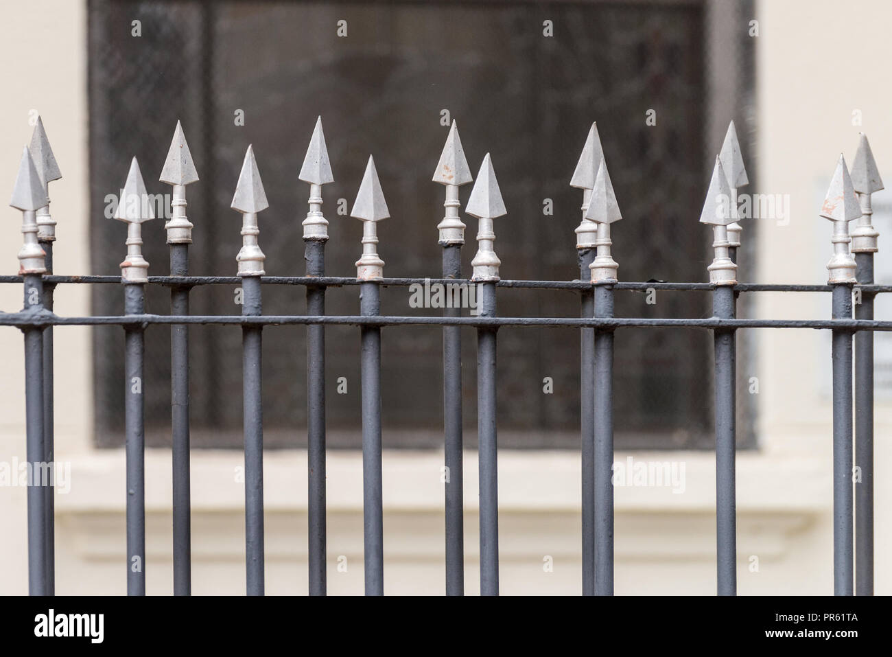 Forged iron fence with sharp arrows to protect Stock Photo - Alamy