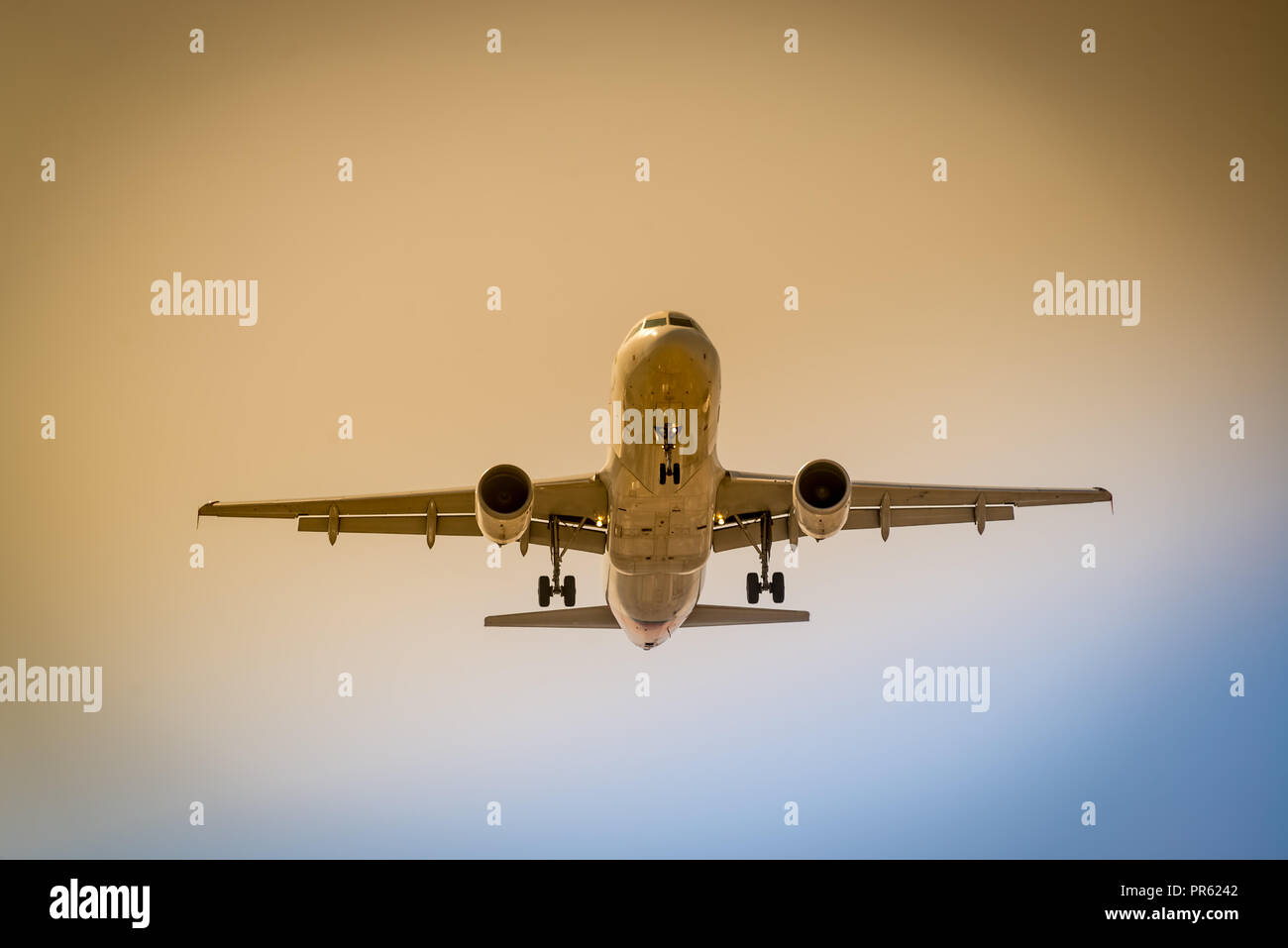 Big airplane flying on crazy dark sky with land gear down Stock Photo ...