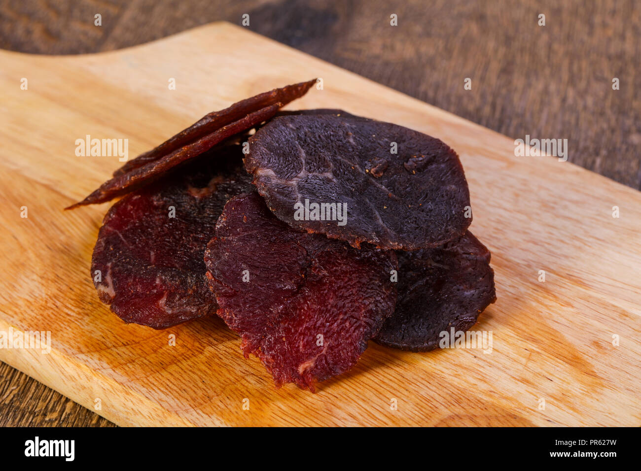 Dry beef meat over wooden Stock Photo - Alamy
