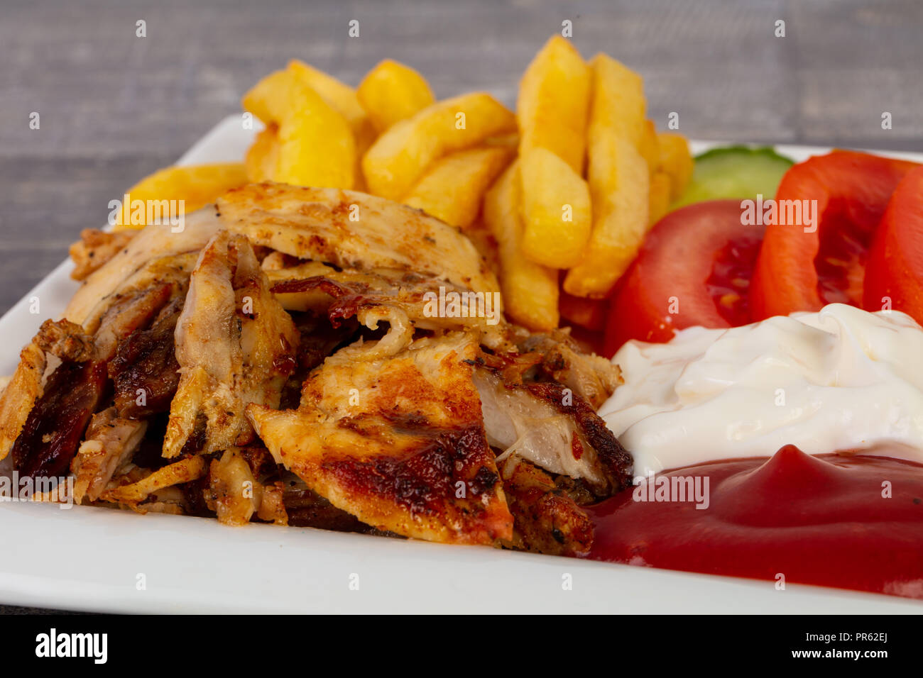 shawarma in plate with fried potato Stock Photo - Alamy