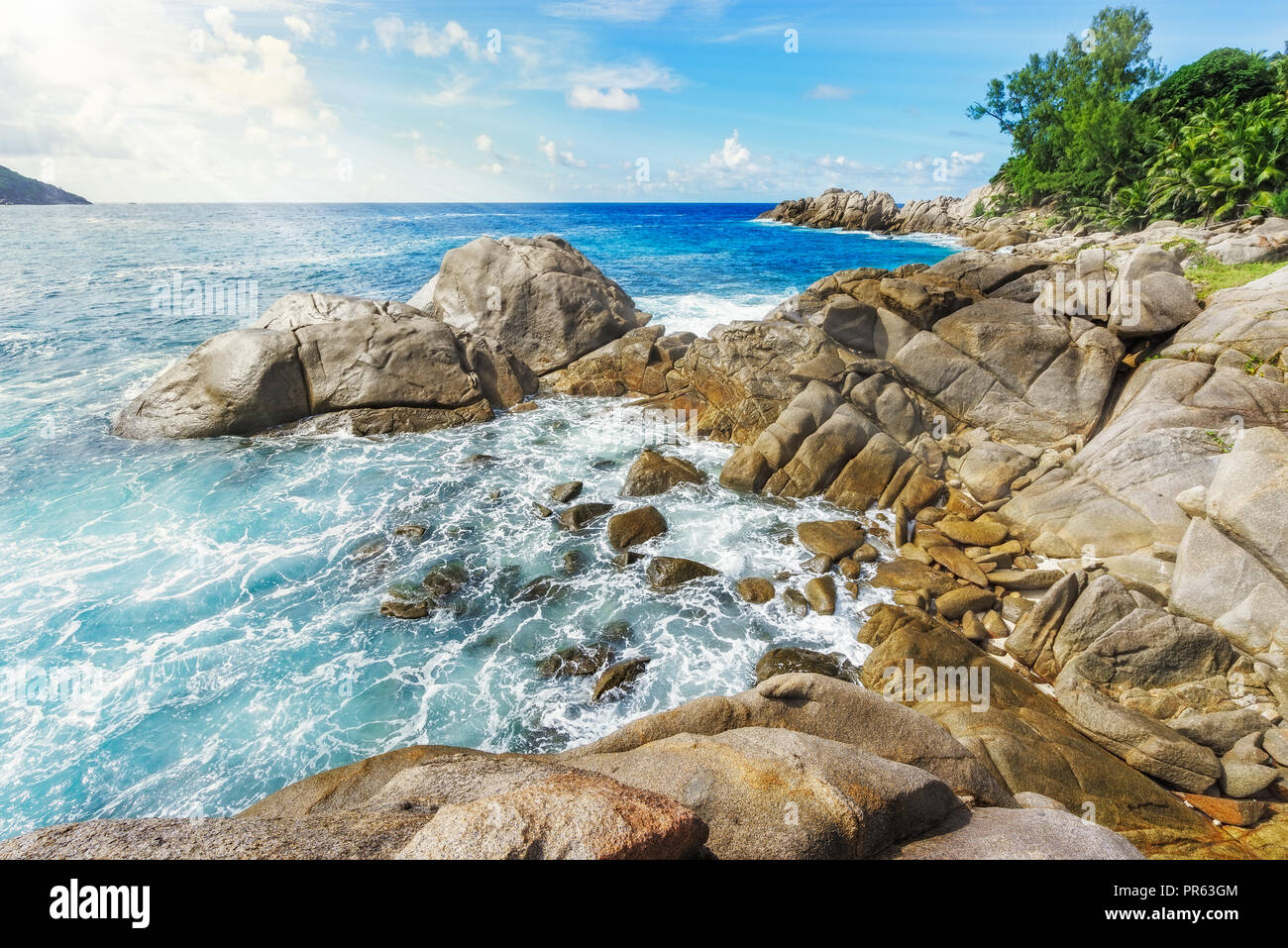 Beautiful and wild lonely beach with rough granite rocks, white sand ...