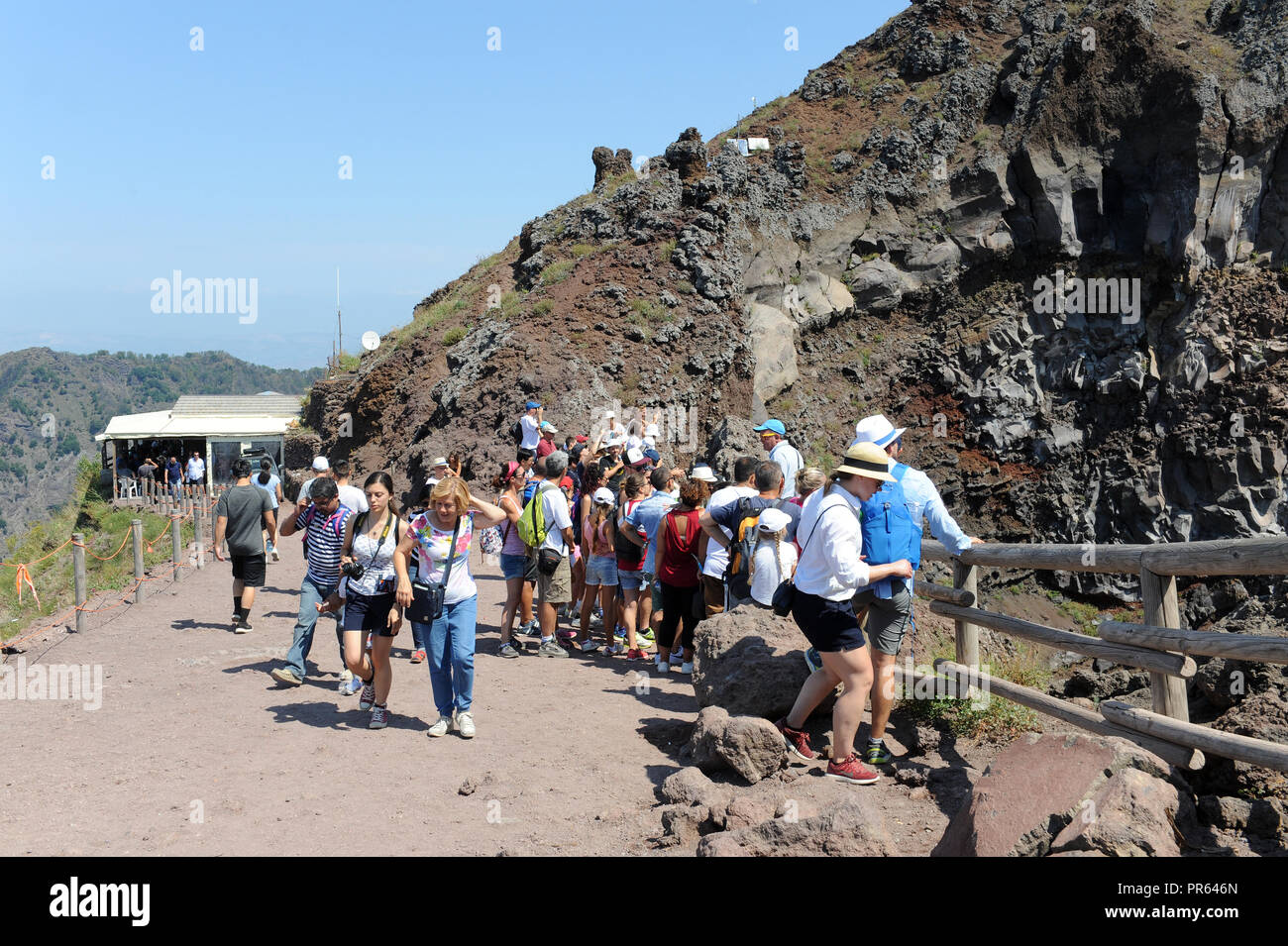 Tourists walking upMount Vesuvius an active volcano above the Bay of ...