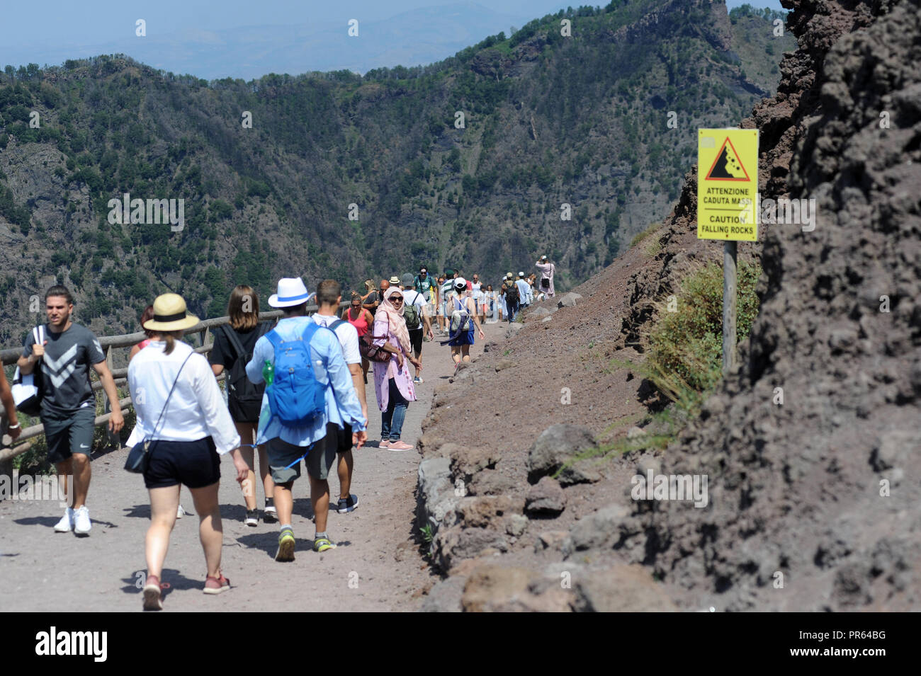 Tourists walking upMount Vesuvius an active volcano above the Bay of ...