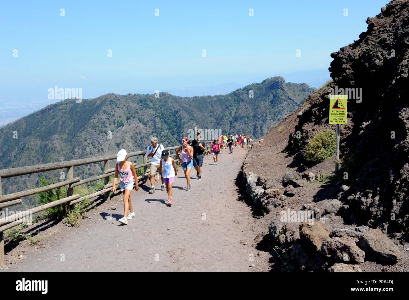 Tourists walking upMount Vesuvius an active volcano above the Bay of ...