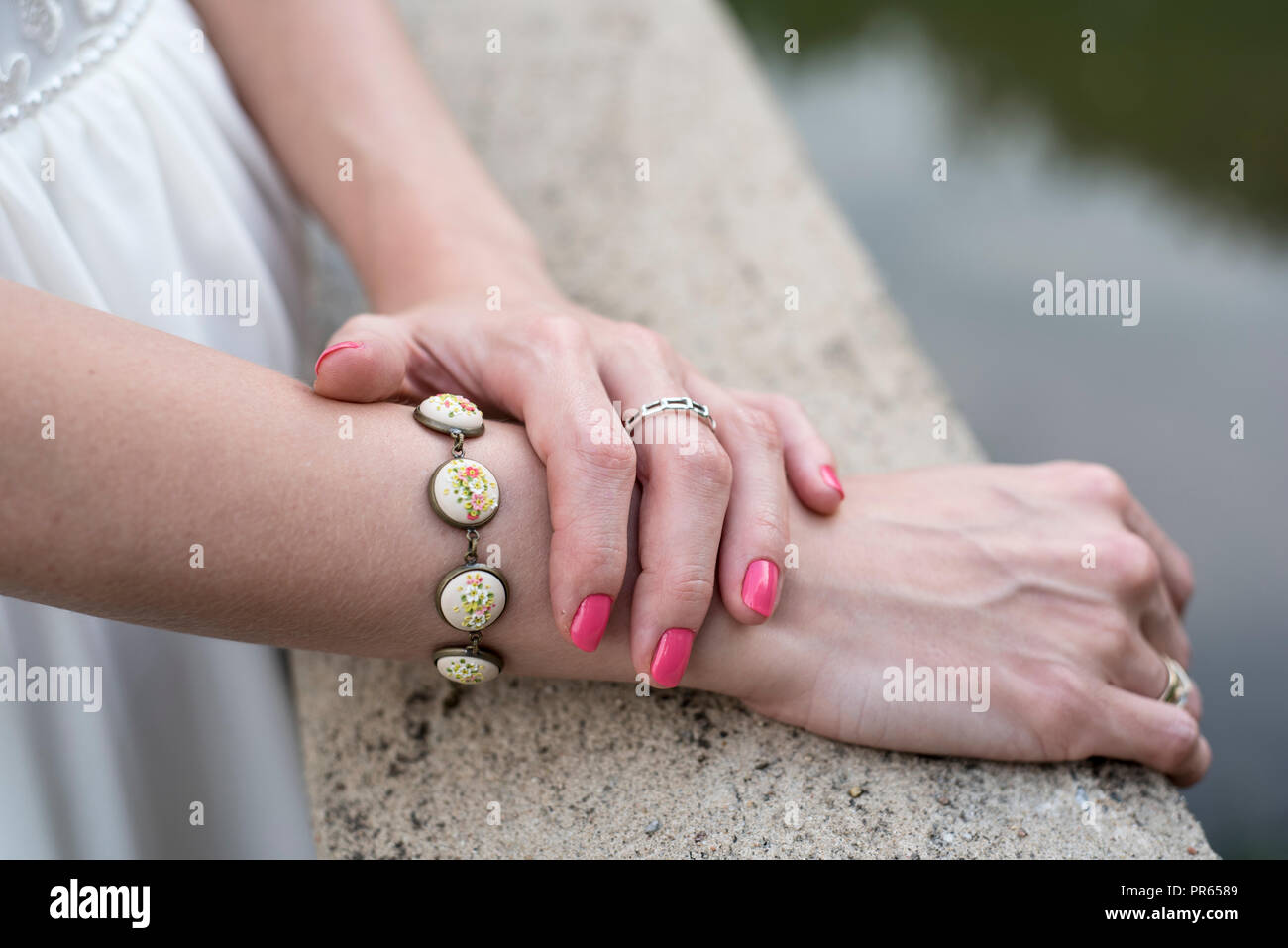 Bride's hands resting on a wall Stock Photo - Alamy