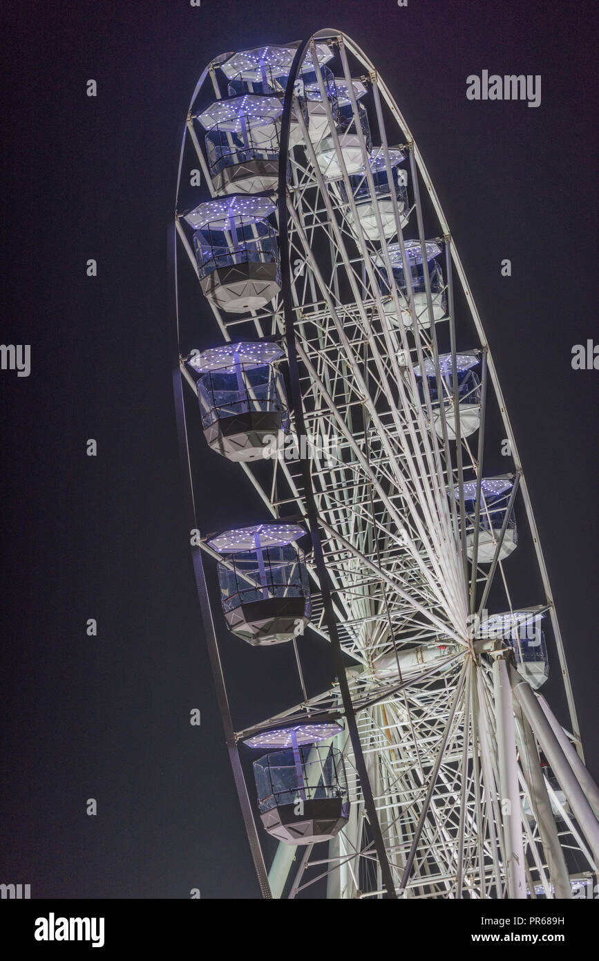 a large fairground ferris or big wheel ride illuminated and lit with ...