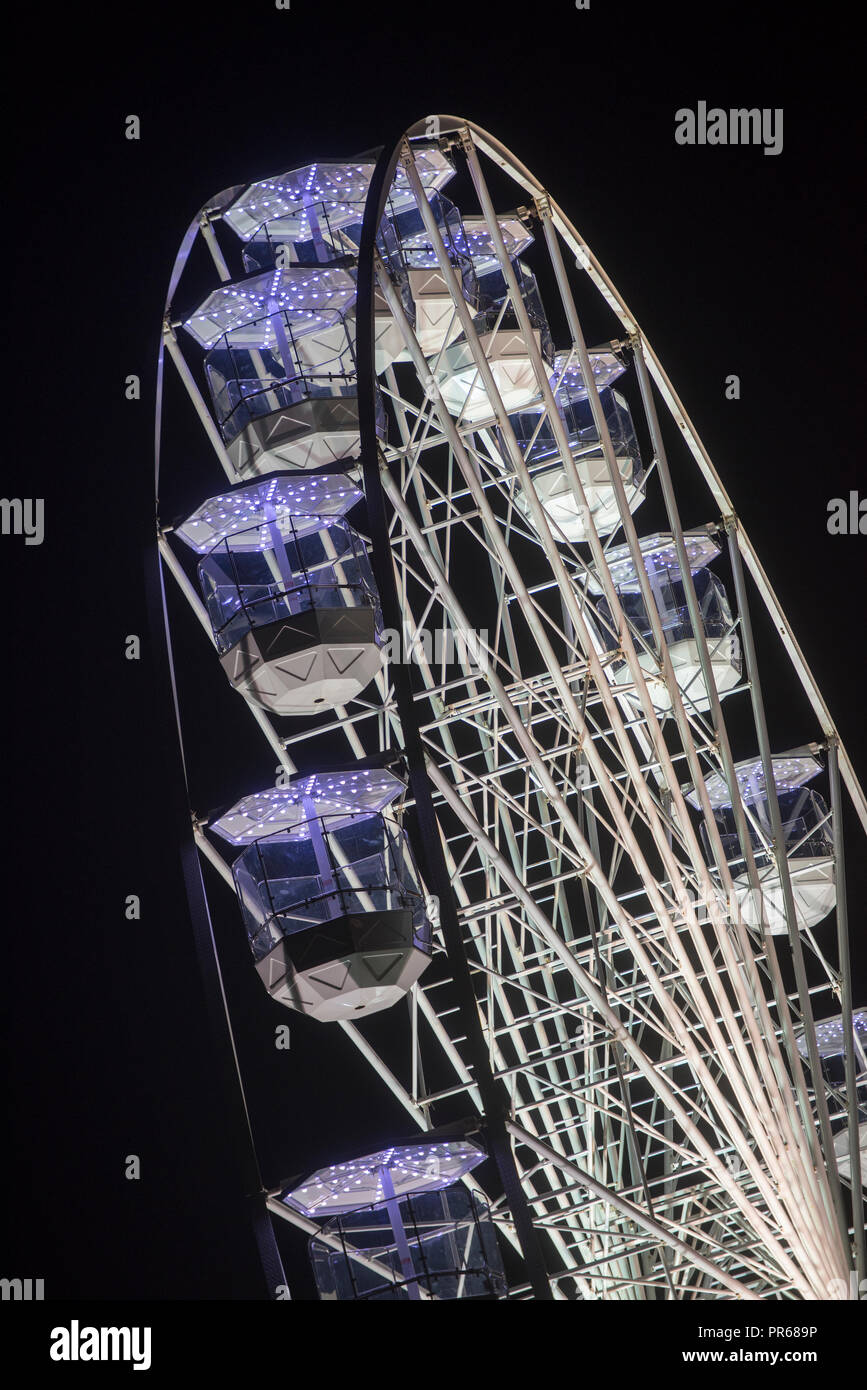 a large fairground ferris or big wheel ride illuminated and lit with ...