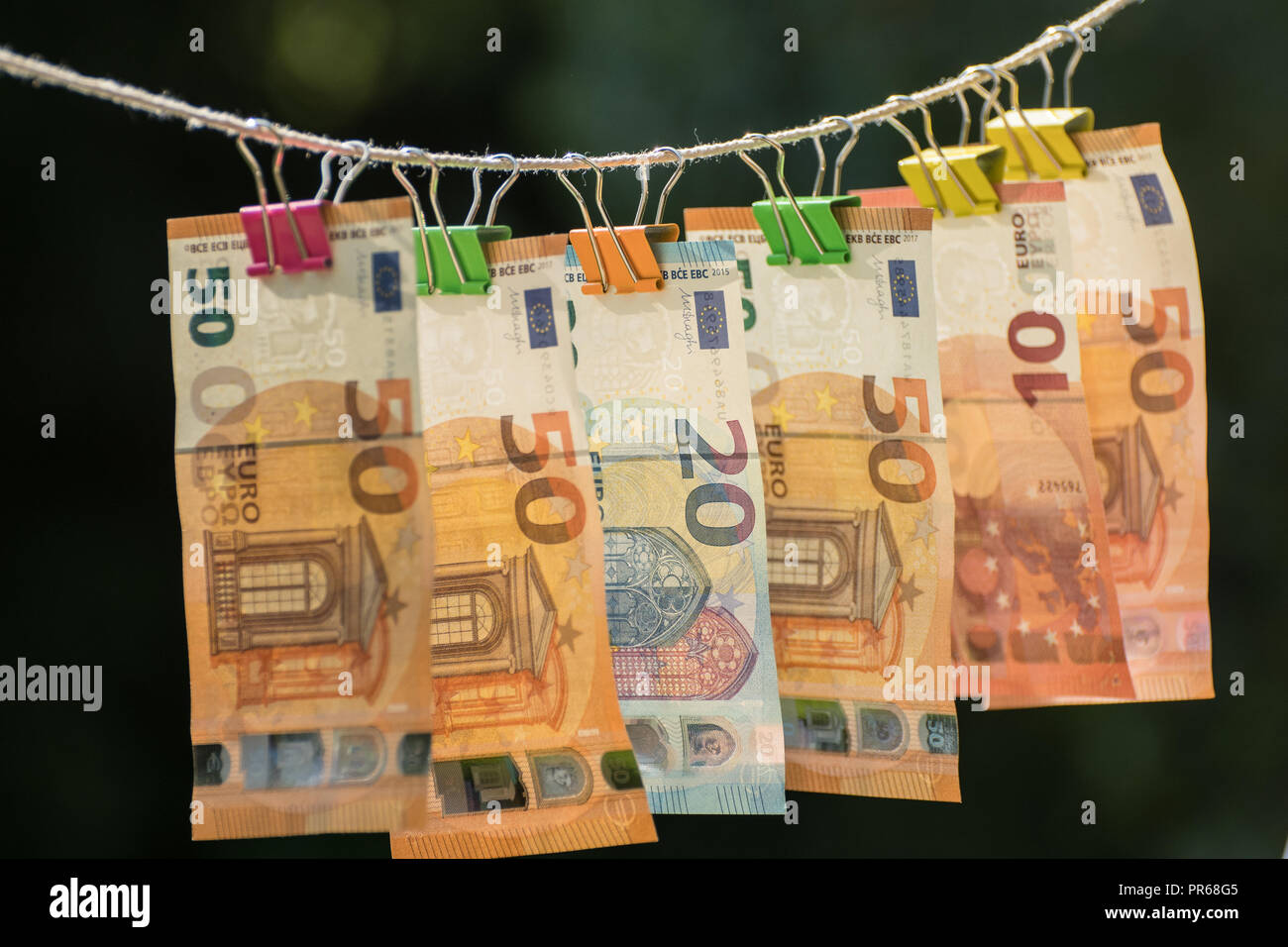 Euro money drying on a clothes line after getting wet Stock Photo - Alamy