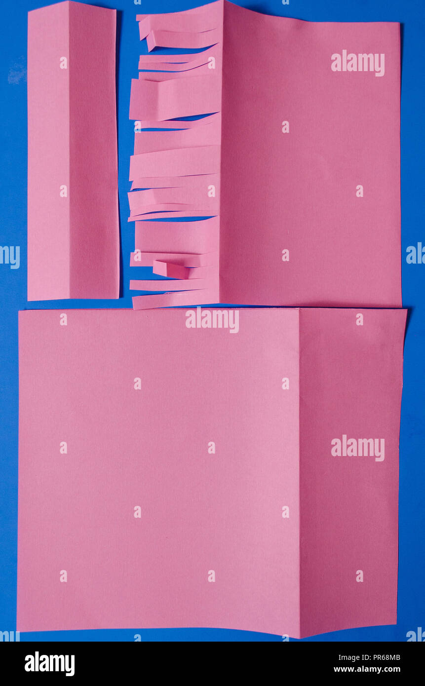 Pink paper cutouts on an isolated blue background, three-dimensional ...