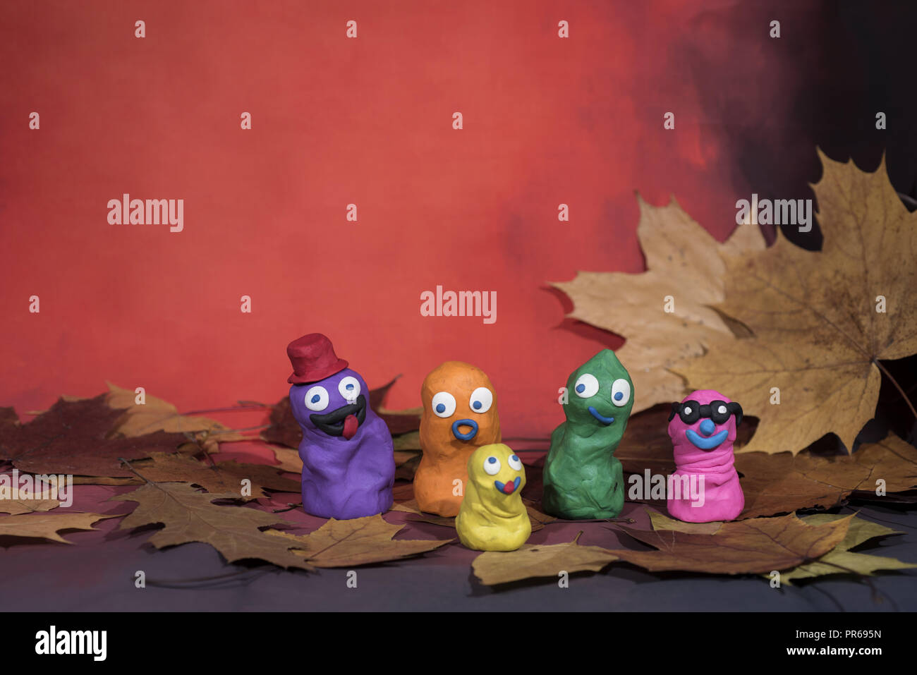 Small funny figures made from Play Clay. Autumn abstraction Stock Photo ...