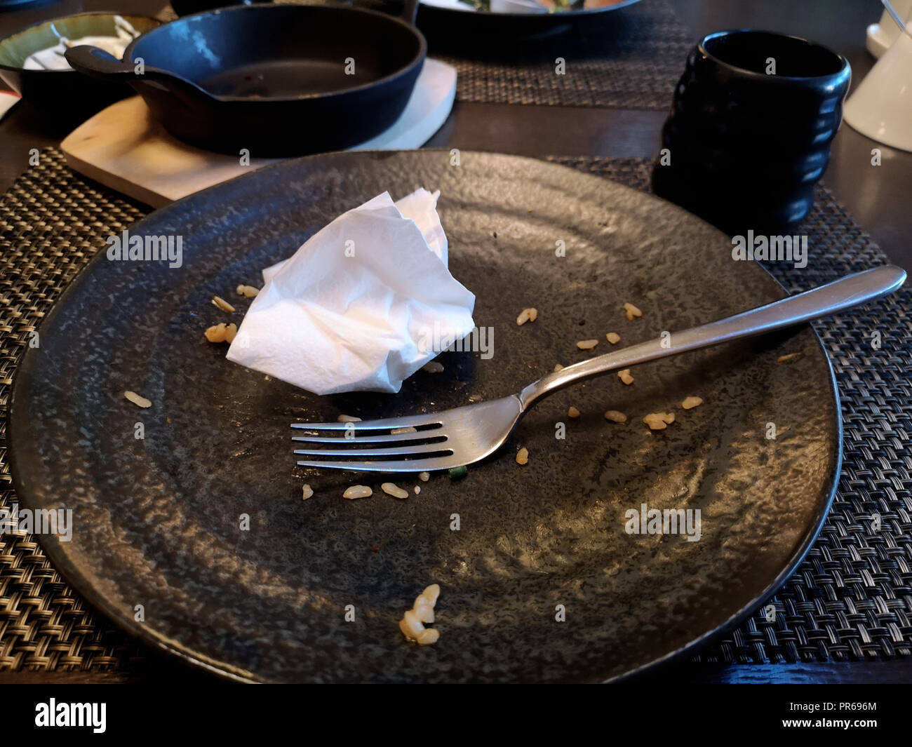 Empty black plate on restaurant table. Abstract photo Stock Photo - Alamy