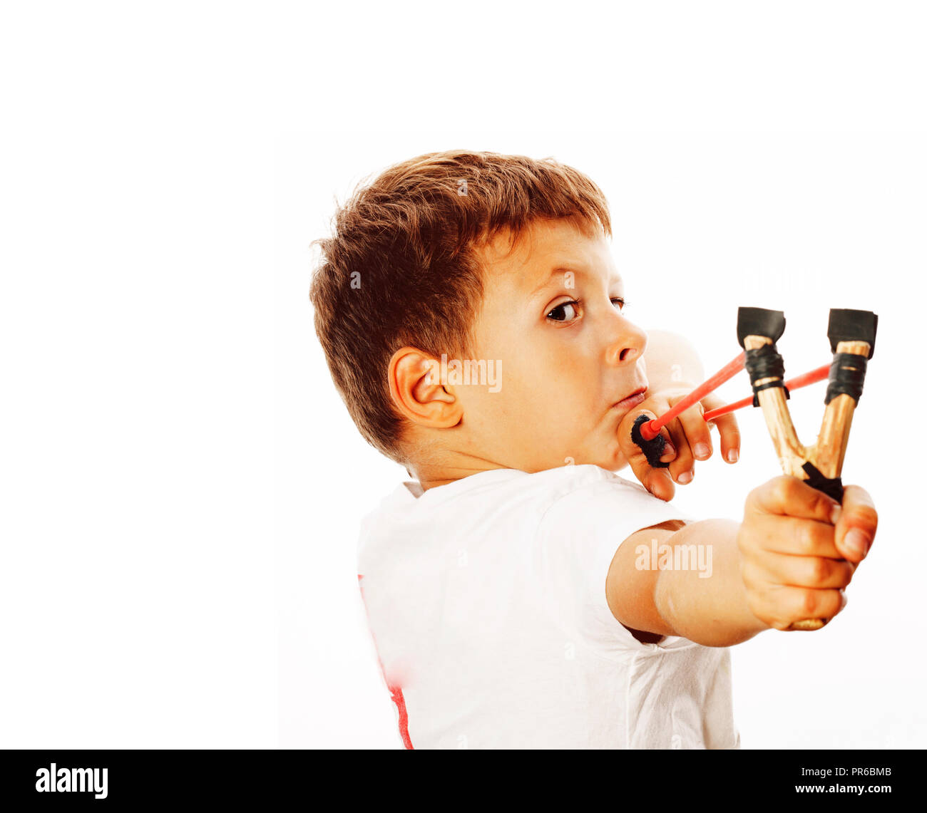 little cute angry real boy with slingshot isolated Stock Photo - Alamy