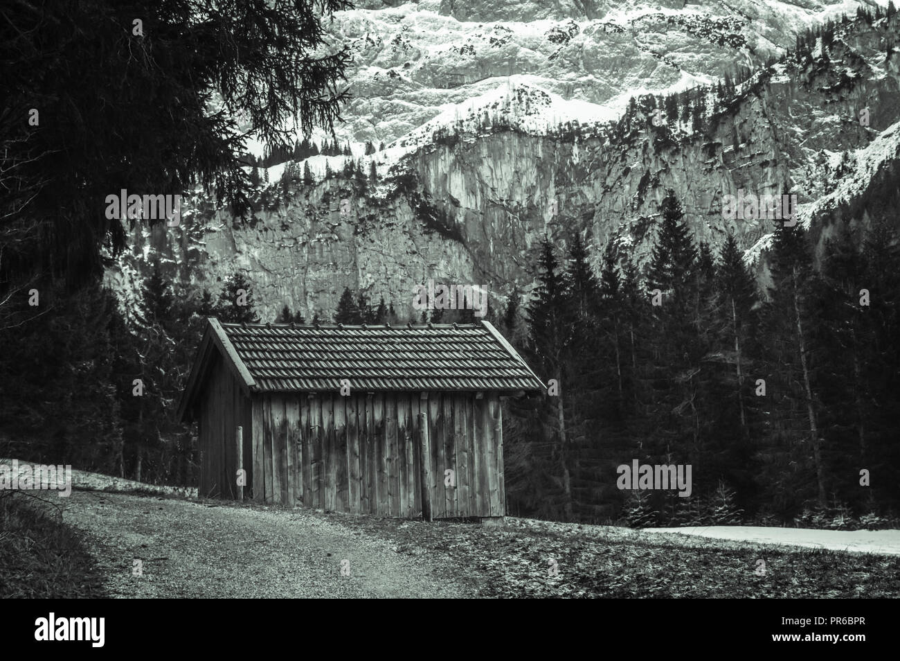 Winter scene with an aged wooden barn in the middle of the austrian ...