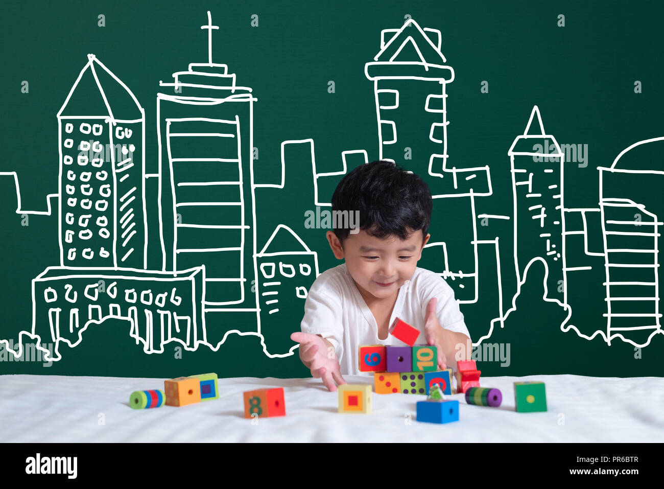 Asian kid learning by playing with his imagination about building and ...