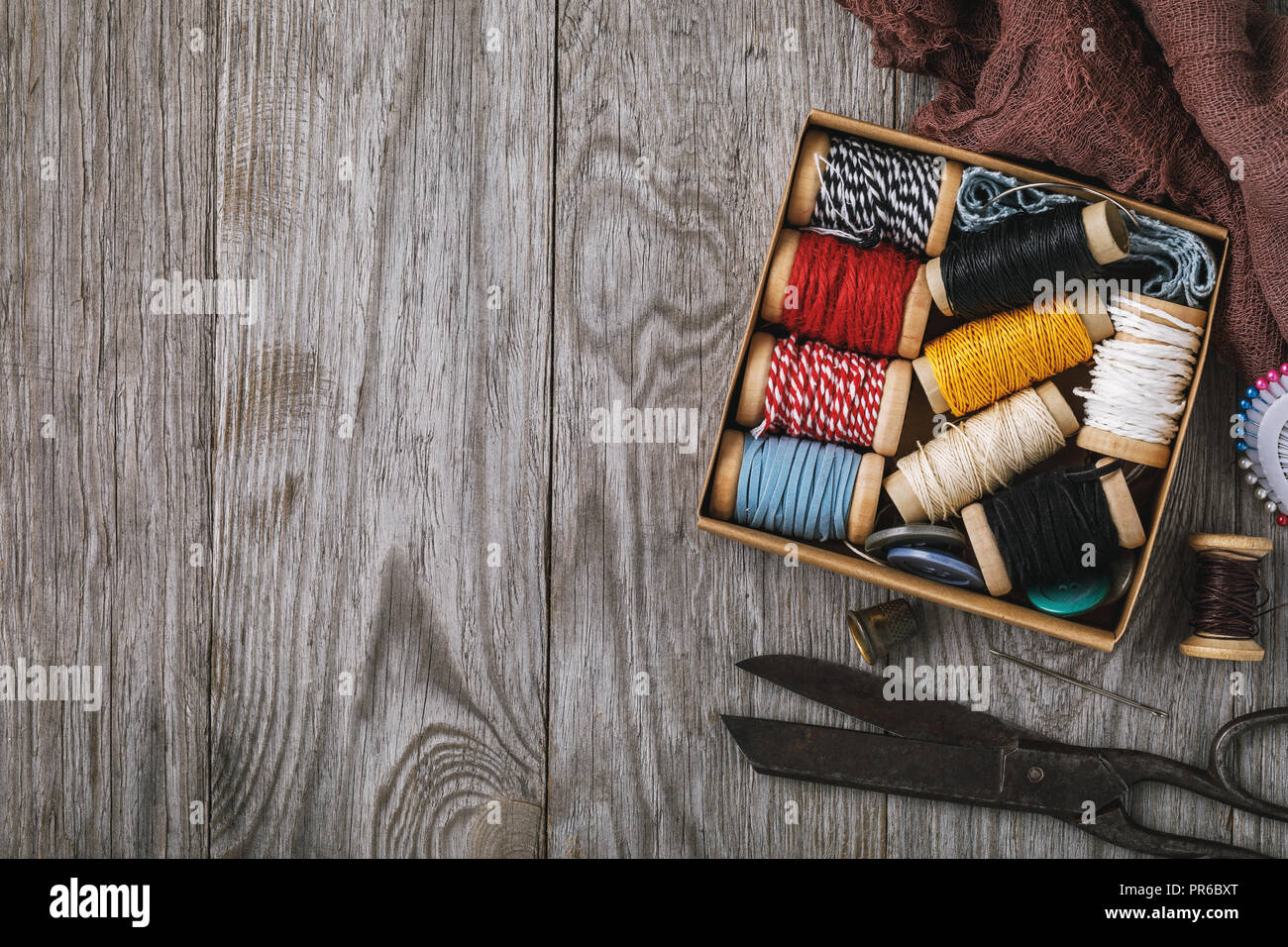 Set of different threads and tools for needlework with copy space, top ...