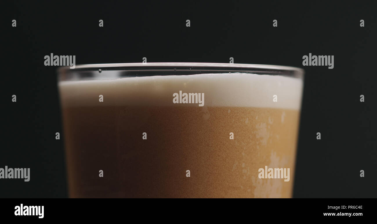 closeup ale beer in a glass over black background Stock Photo - Alamy