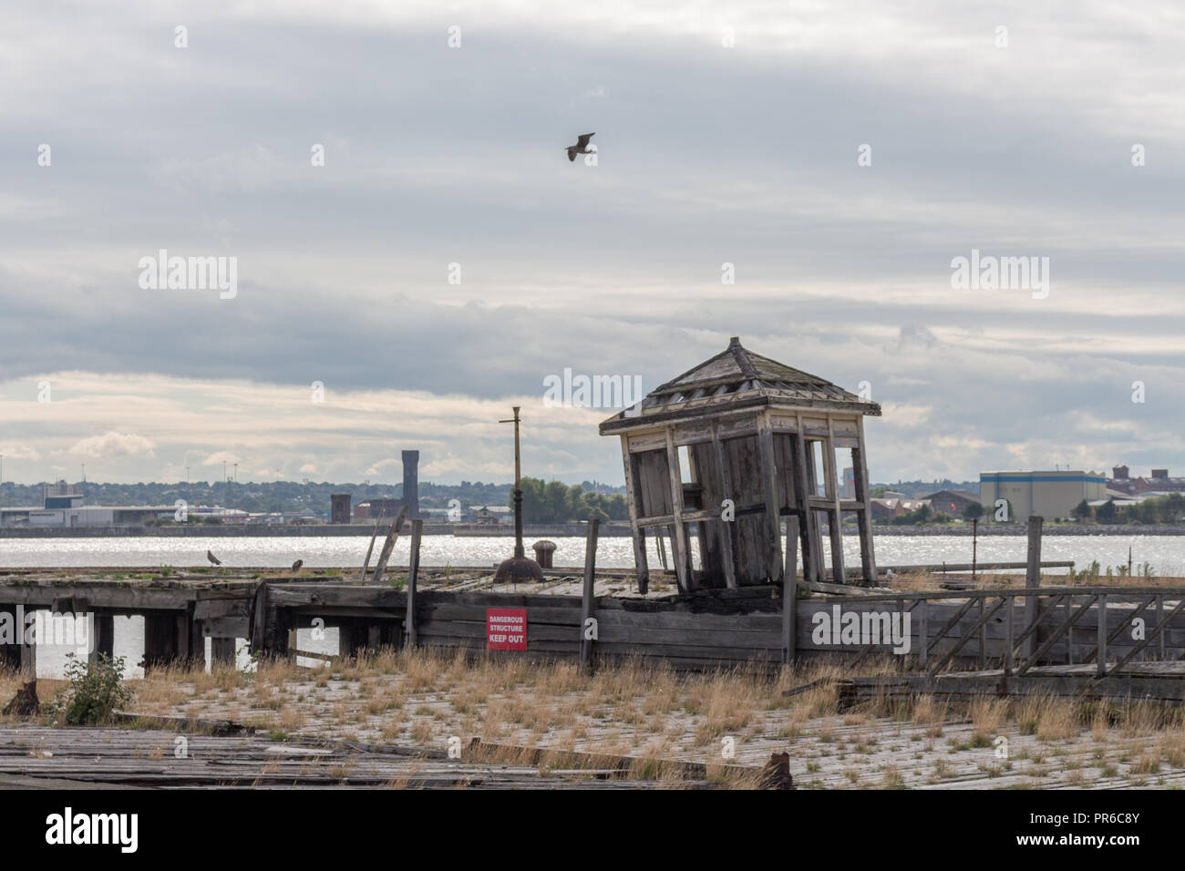 Derelict structures at Liverpool docks with Birkenhead in background ...