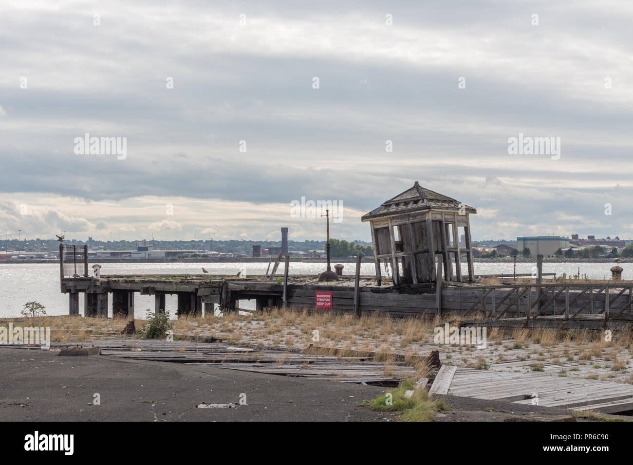 Derelict structures at Liverpool docks with Birkenhead in background ...