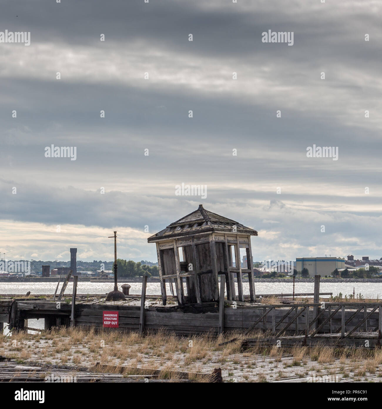 Derelict structures at Liverpool docks with Birkenhead in background ...
