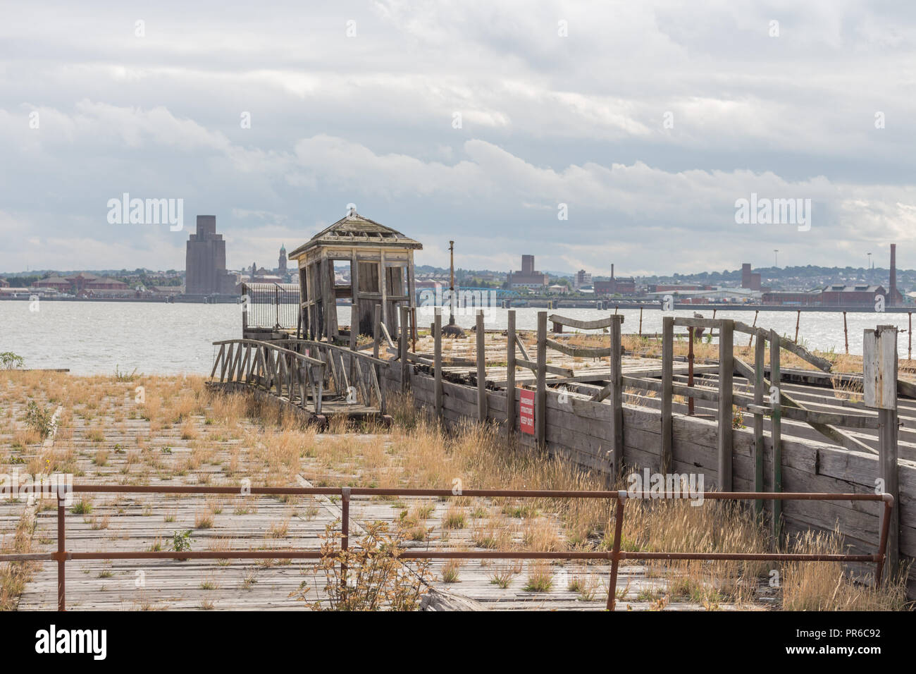 Derelict structures at Liverpool docks with Birkenhead in background ...