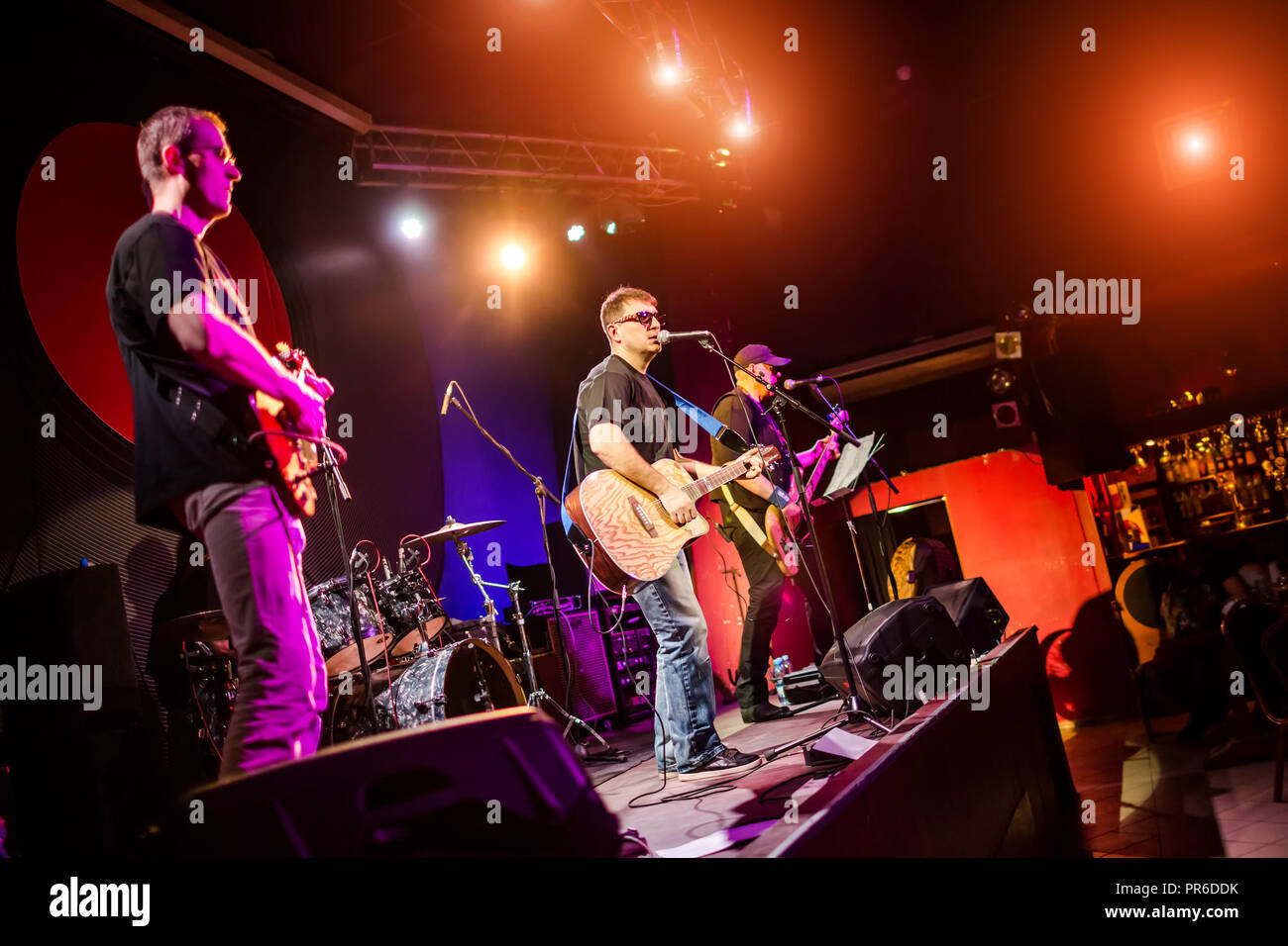 Band performs on stage, rock music concert in a nightclub. Authentic ...